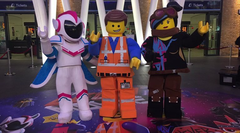 Pink Singers choir sing The LEGO Movie 2 songs for commuters at Kings Cross